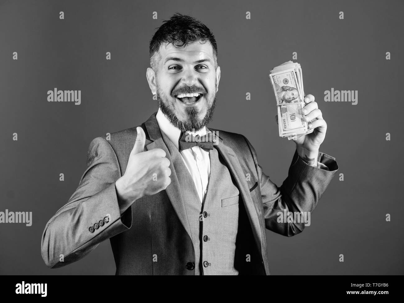 Cash transaction business. Man happy winner rich hold pile of dollar ...