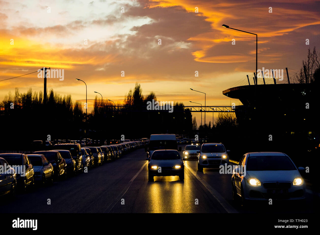 Rush hour traffic urban scene at sunset Stock Photo - Alamy