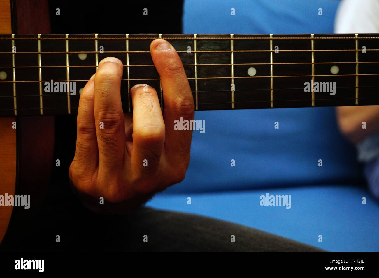 Playing guitar hands on the strings close up view Stock Photo - Alamy