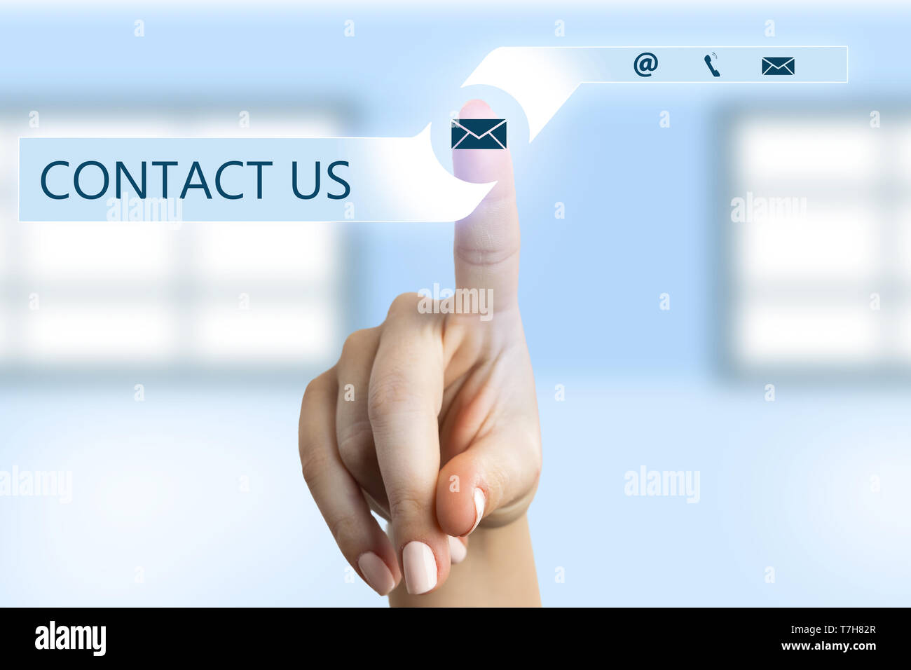 Woman pressing email symbol with index finger on invisible screen ...