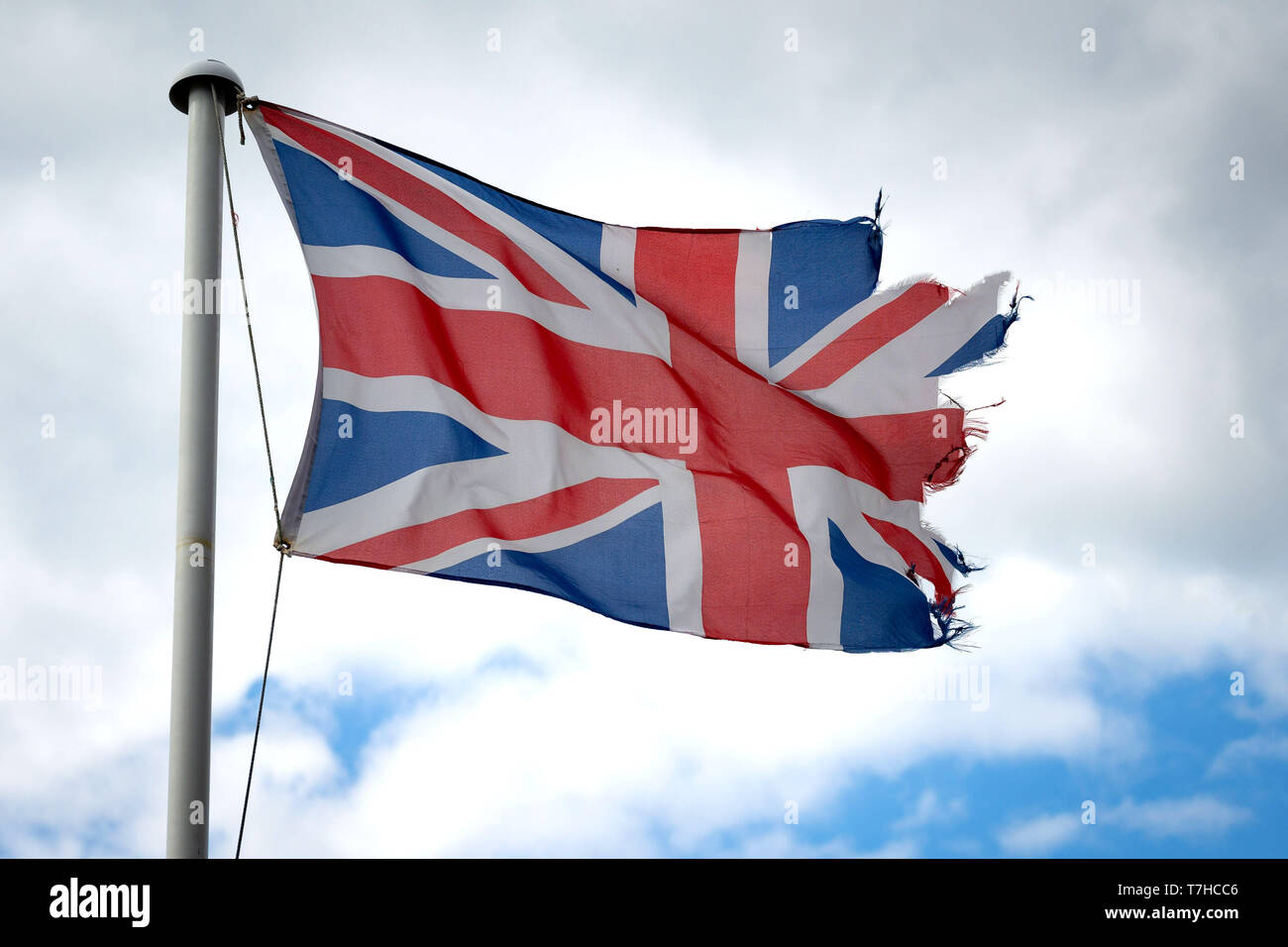 A torn damaged GB Union Jack flag flying in the wind Stock Photo - Alamy