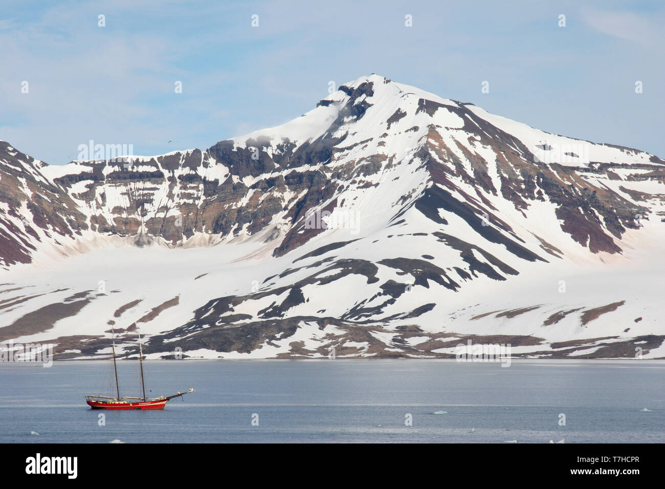 Sailing boat in landscape Svalbard, Arctic Norway, with snow-covered ...