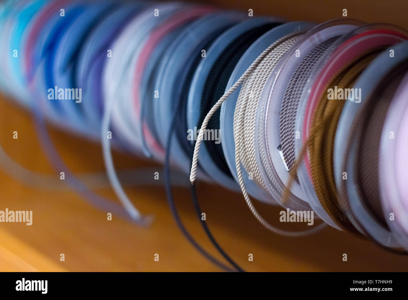 Close-up of many reels with colorful ribbons for the design of bouquets ...