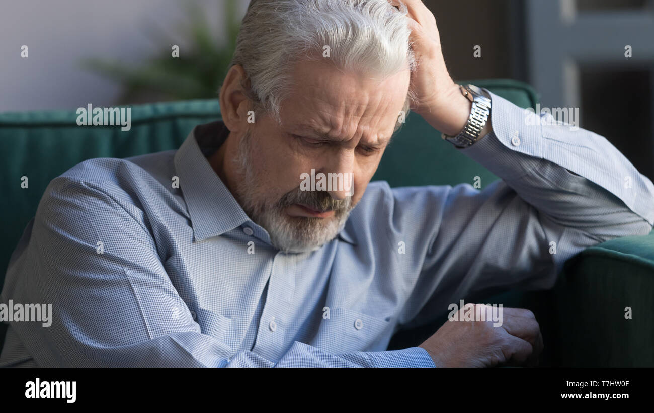 Unhappy lonely grey haired mature man sitting alone horizontal banner ...