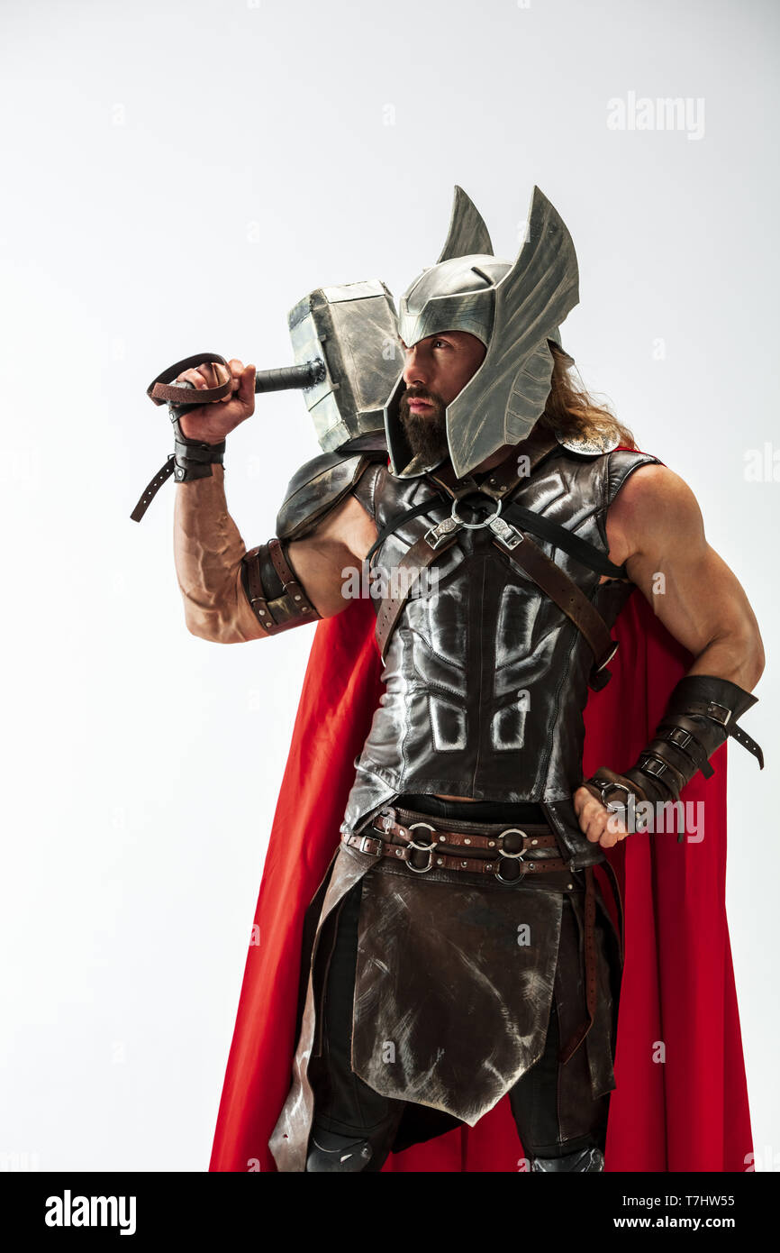 Long hair and muscular male model in leather viking's costume with the ...