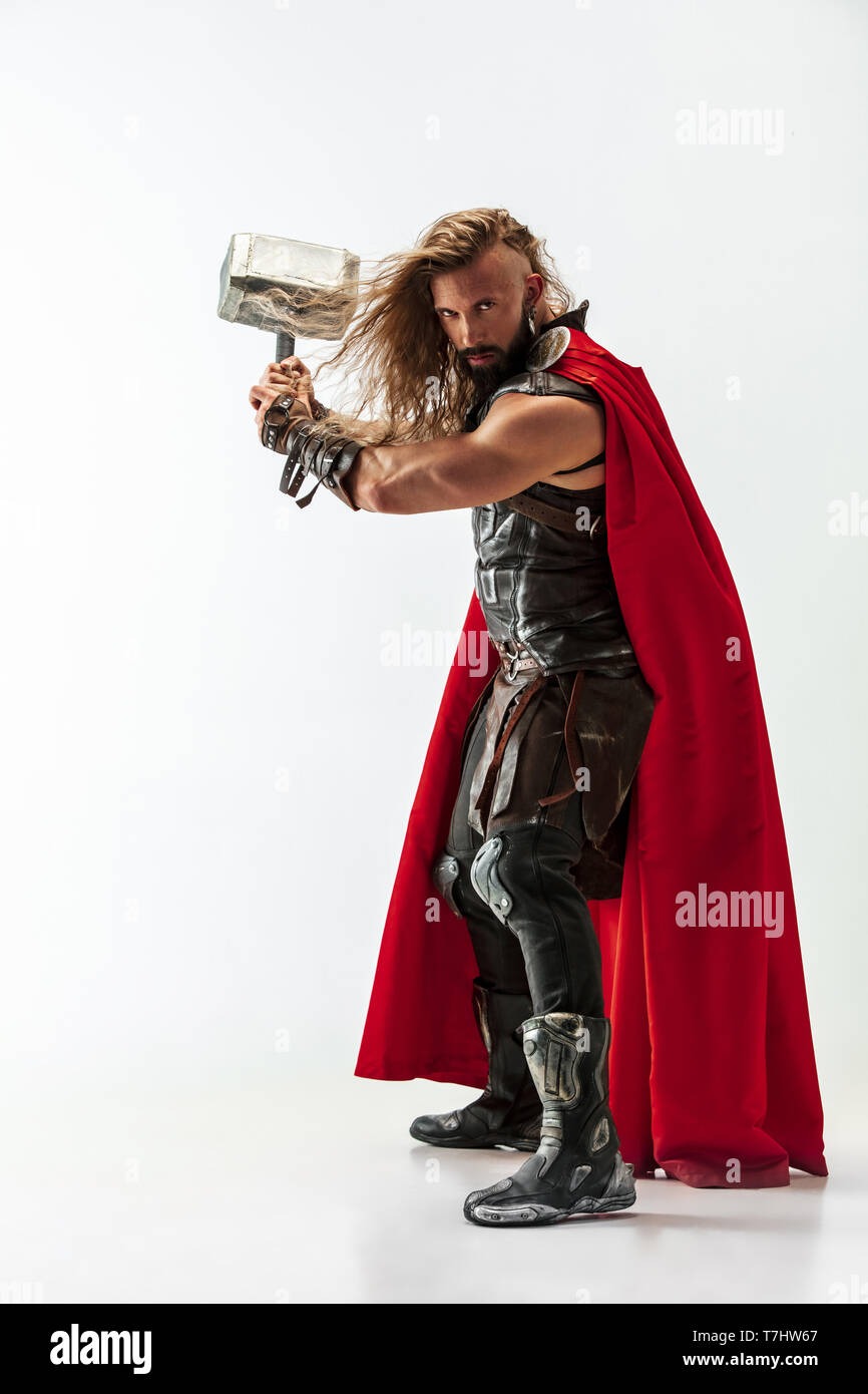 Long hair and muscular male model in leather viking's costume with the ...