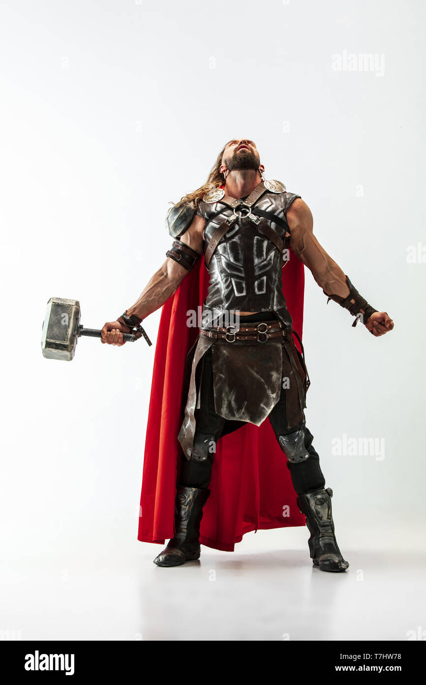 Long hair and muscular male model in leather viking's costume with the ...