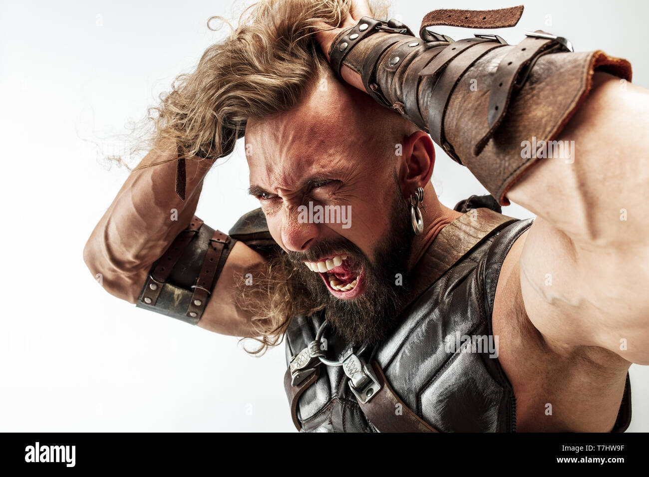 Strenght and energy. Blonde long hair and muscular male model in ...