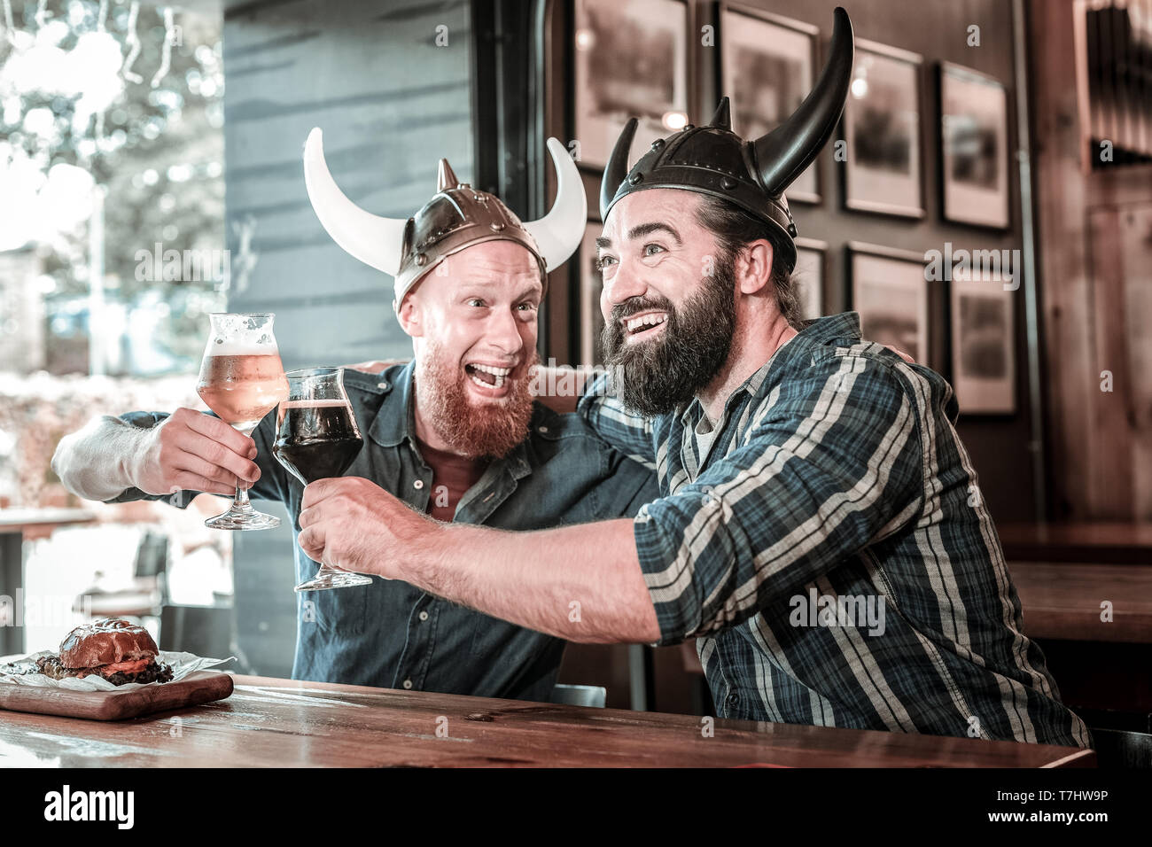Two friends wearing viking helmets and laughing Stock Photo - Alamy