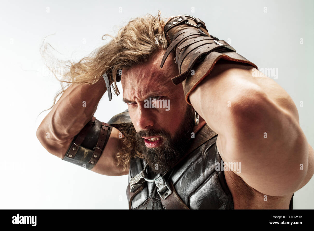 Angry and emotional. Blonde long hair and muscular male model in ...