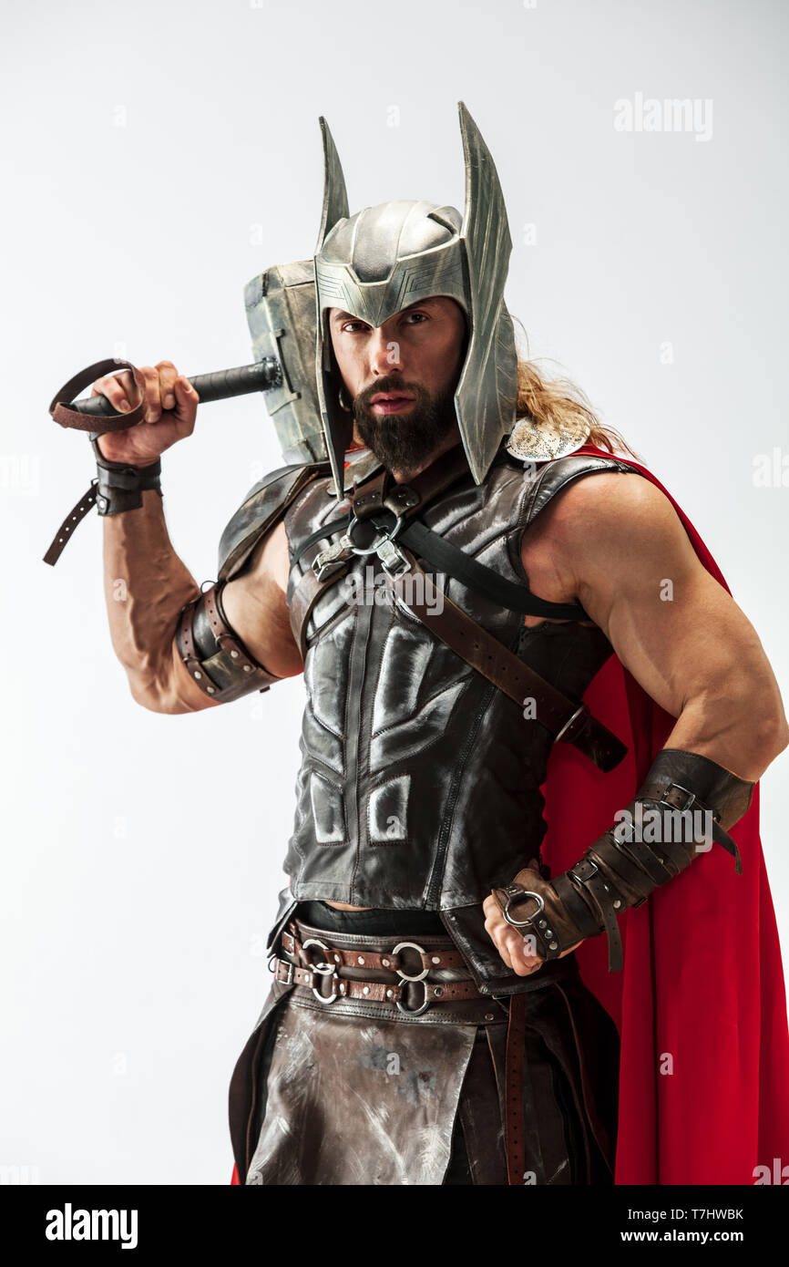 Long hair and muscular male model in leather viking's costume with the ...