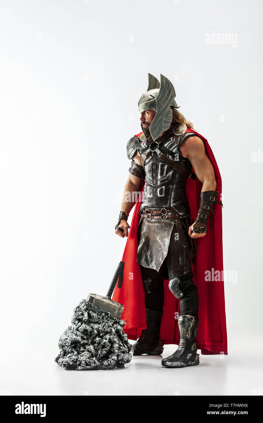 Long hair and muscular male model in leather viking's costume with the ...