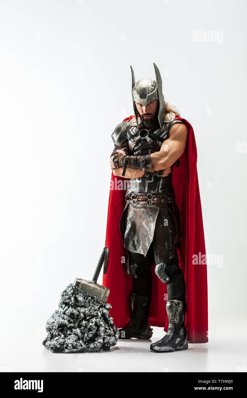 Long hair and muscular male model in leather viking's costume with the ...