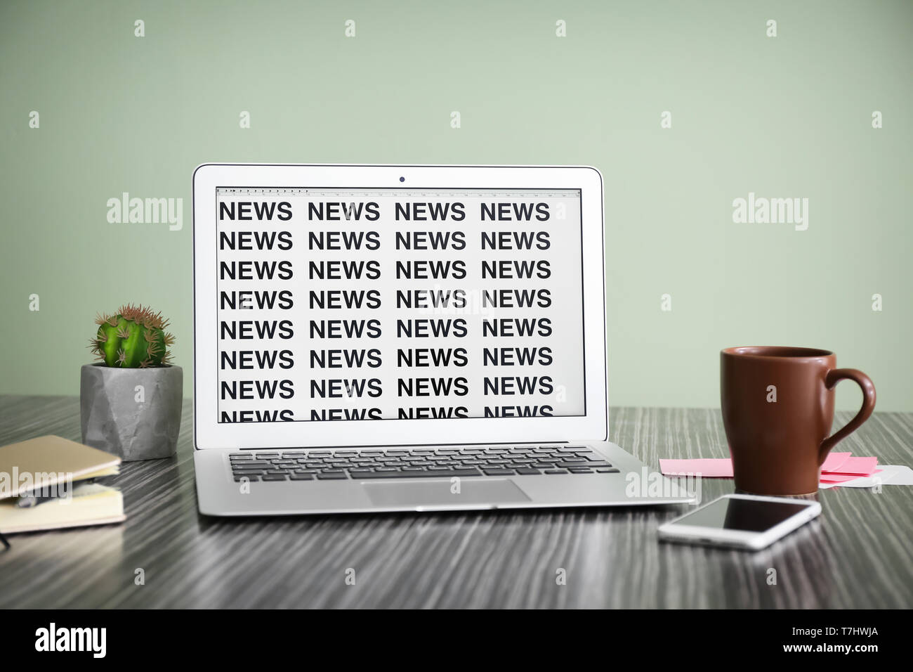 Laptop with words NEWS on screen in room Stock Photo - Alamy