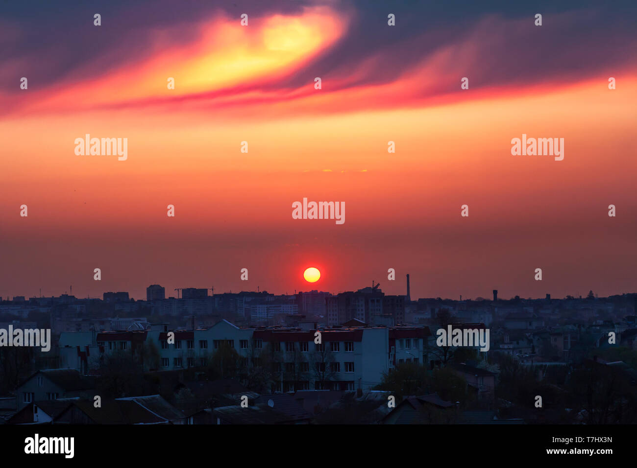 Crimson sunset over dark city. Landscape with red sundown Stock Photo ...