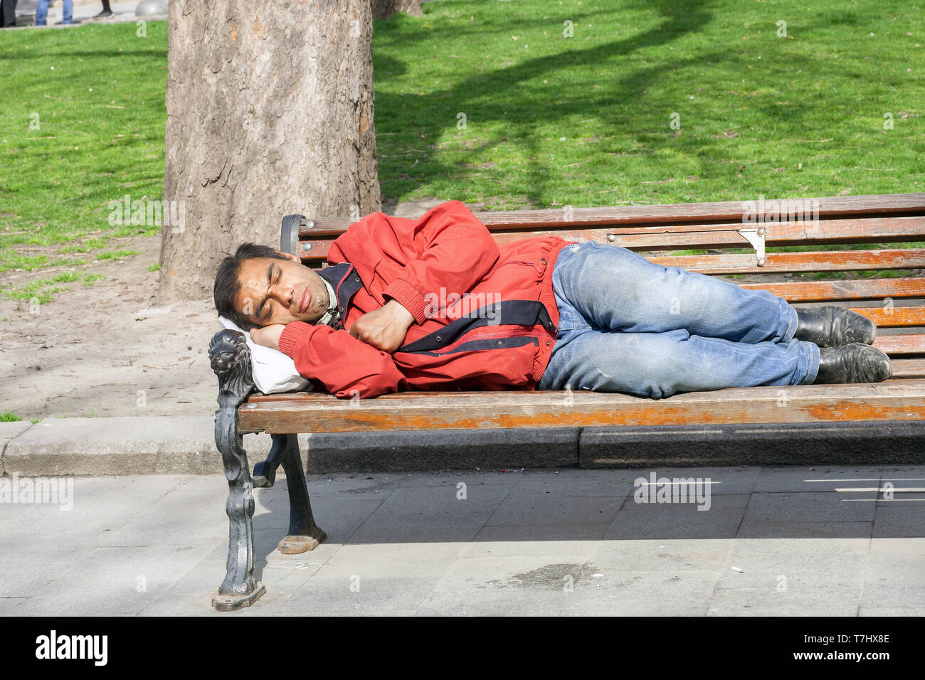 Lviv, Ukraine - 14 April 2019: Homeless man sleeping on wooden bench on ...