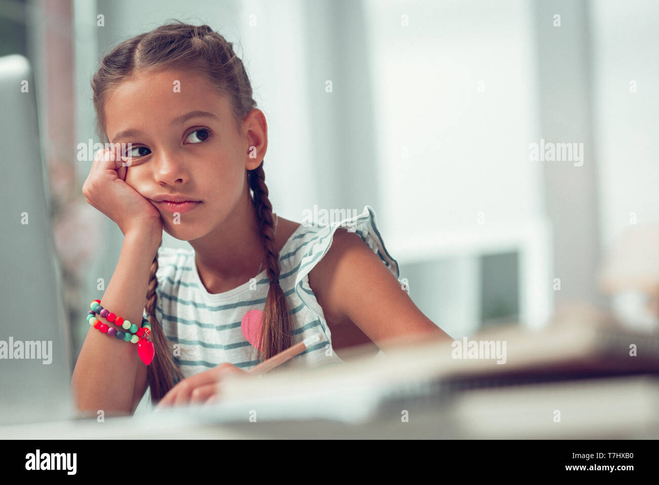 Face portrait of Afro-American schoolchild spending time doing boring ...