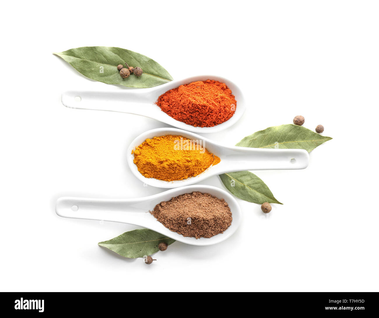 Spoons with various spices on white background Stock Photo - Alamy