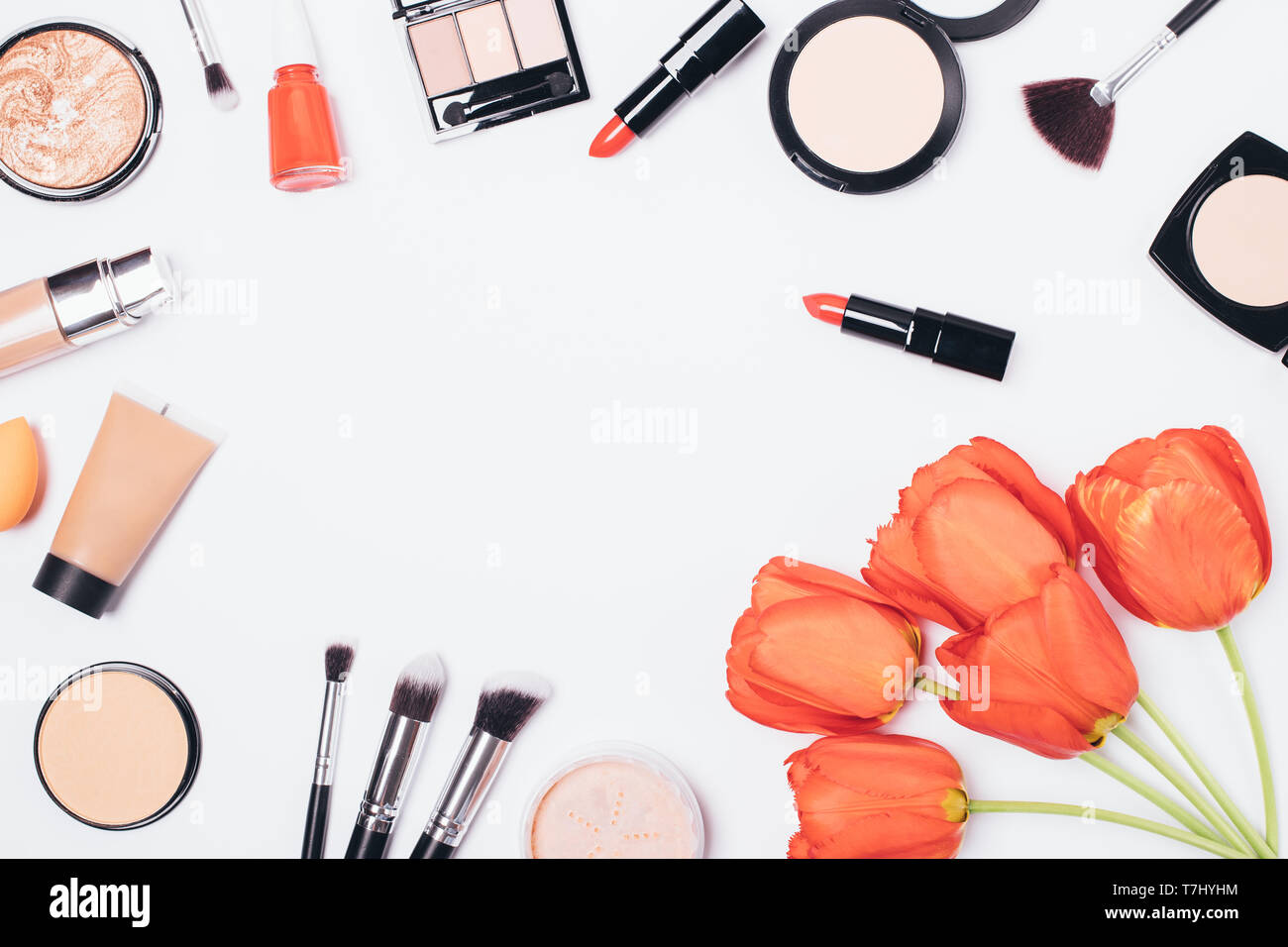 Festive flat lay frame of cosmetic products, makeup accessories and ...