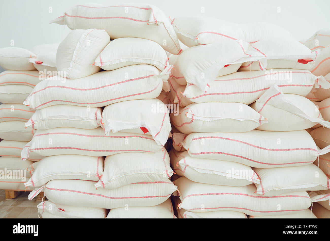 Background of white bags.Many white bags in warehouse Stock Photo - Alamy