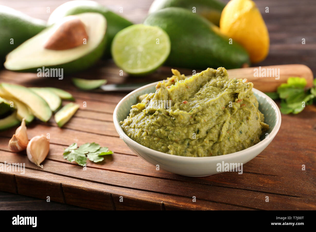 Bowl with delicious guacamole on wooden board Stock Photo - Alamy