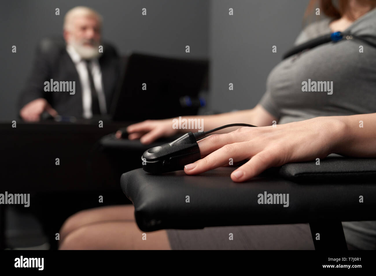 Finger sensor of lie detector on female hand. Sensors and wire for ...