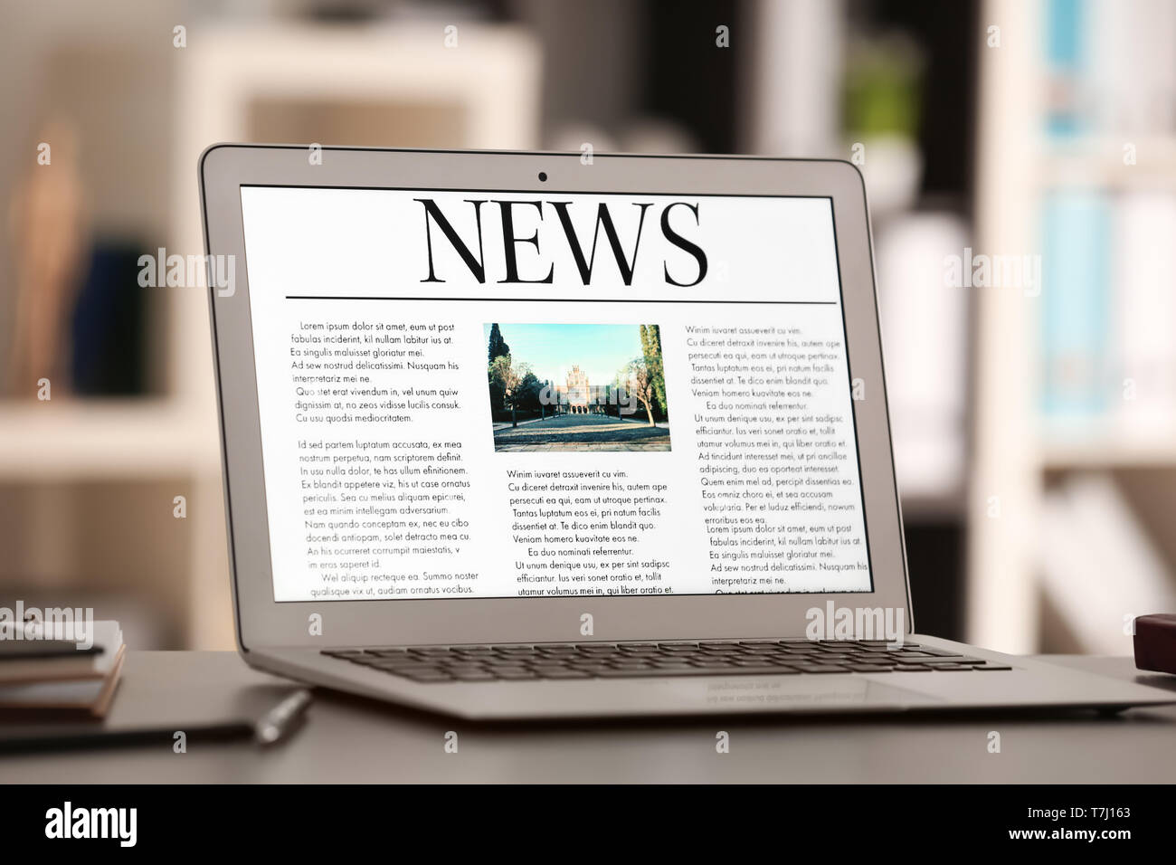 Workplace with laptop and news on screen Stock Photo - Alamy