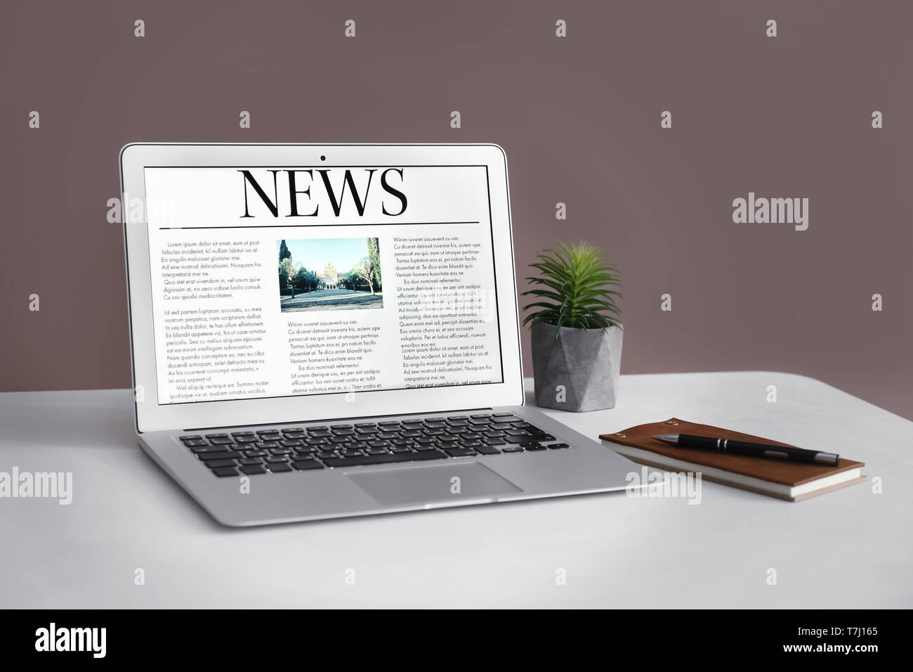 Workplace with laptop and news on screen Stock Photo - Alamy