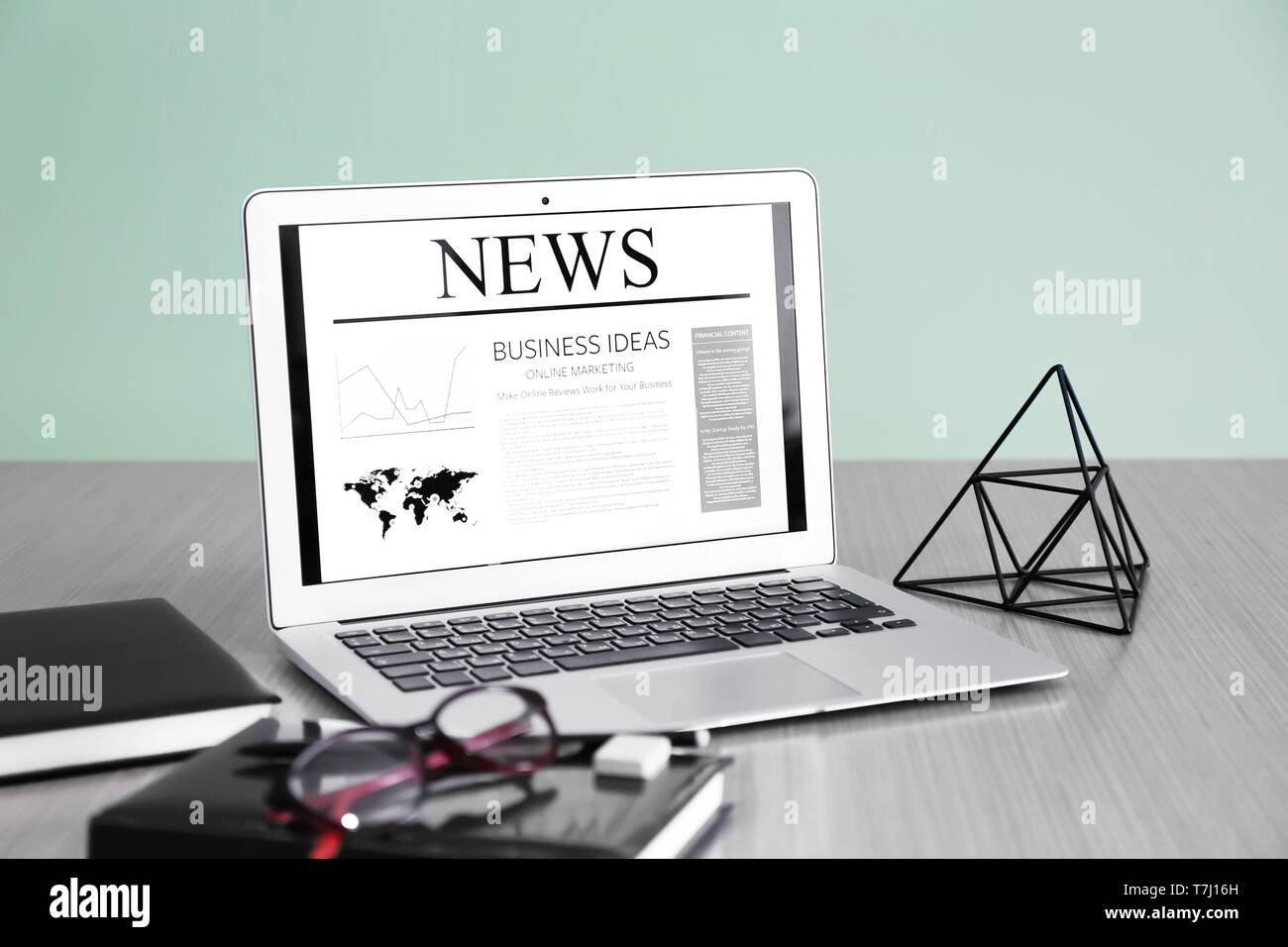 Workplace with laptop and news on screen Stock Photo - Alamy