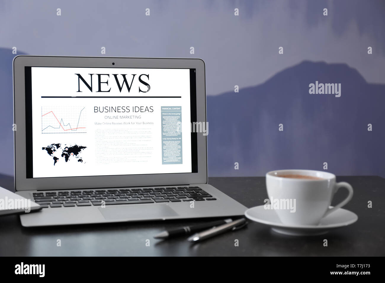 Workplace with laptop and news on screen Stock Photo - Alamy