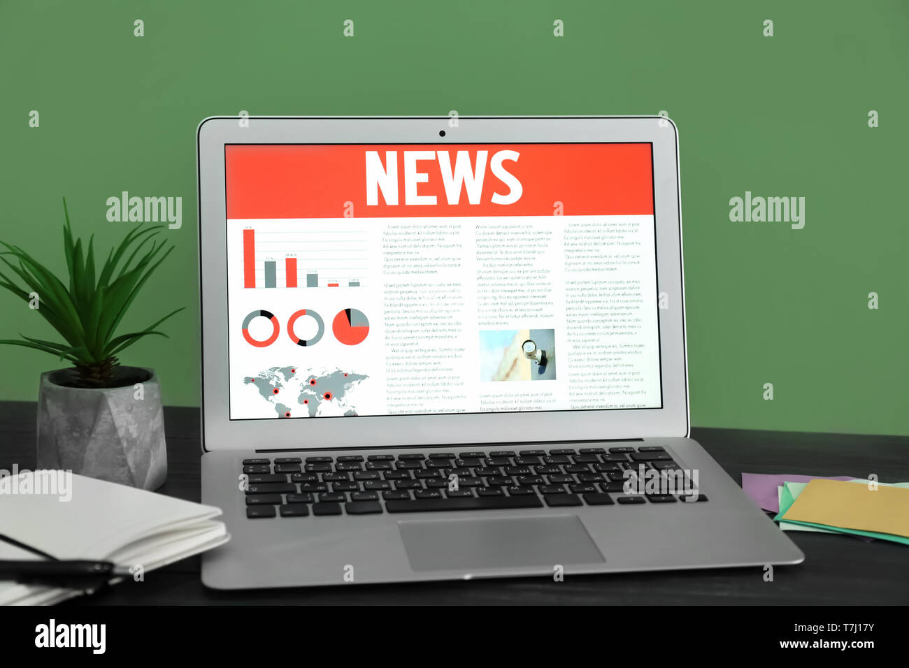 Workplace with laptop and news on screen Stock Photo - Alamy
