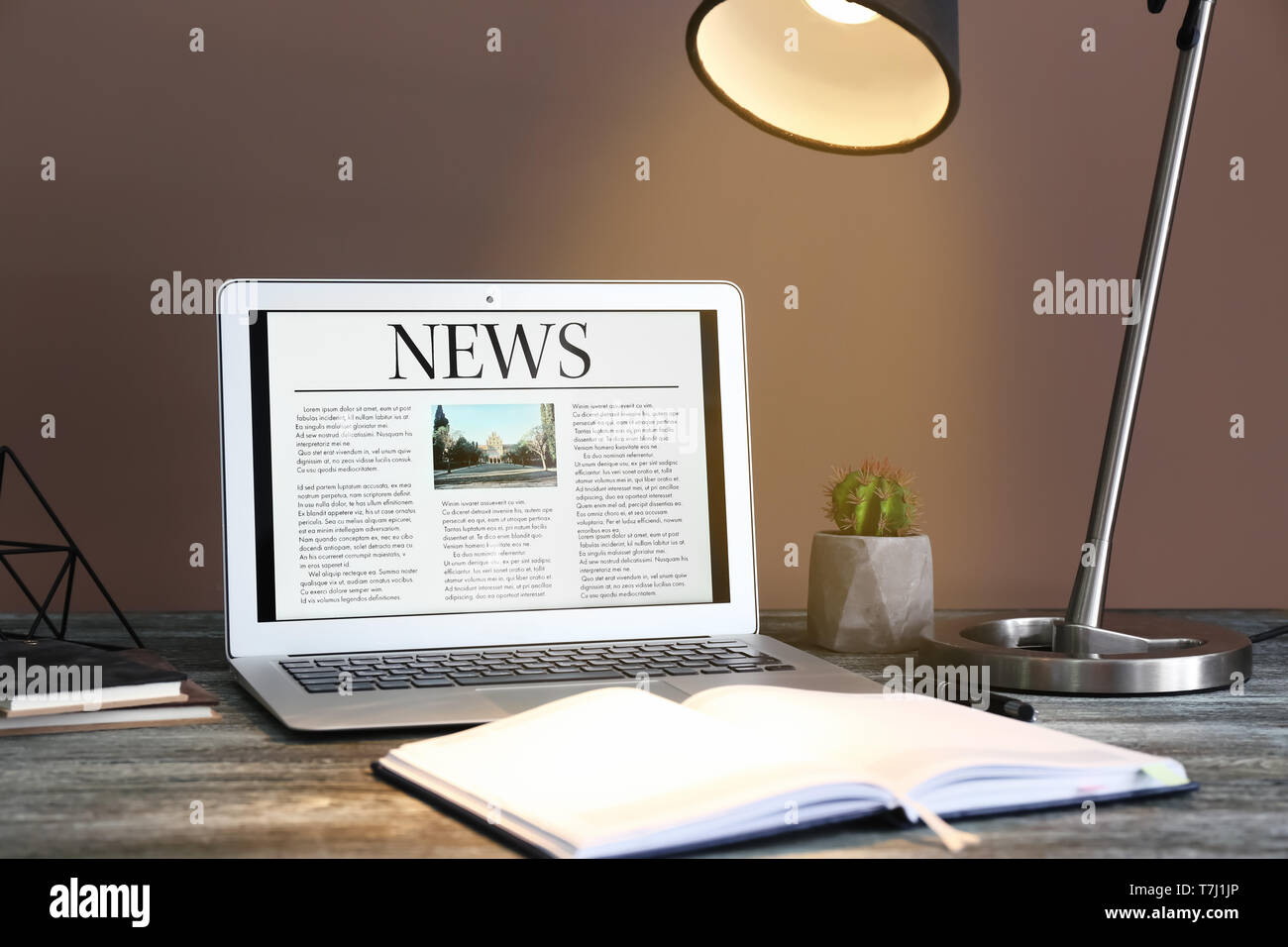 Workplace with laptop and news on screen Stock Photo - Alamy