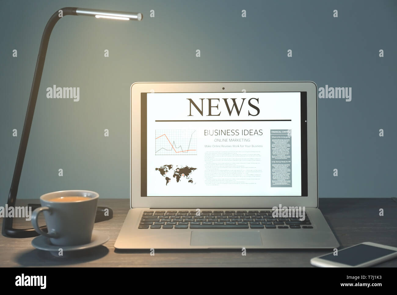 Workplace with laptop and news on screen Stock Photo - Alamy