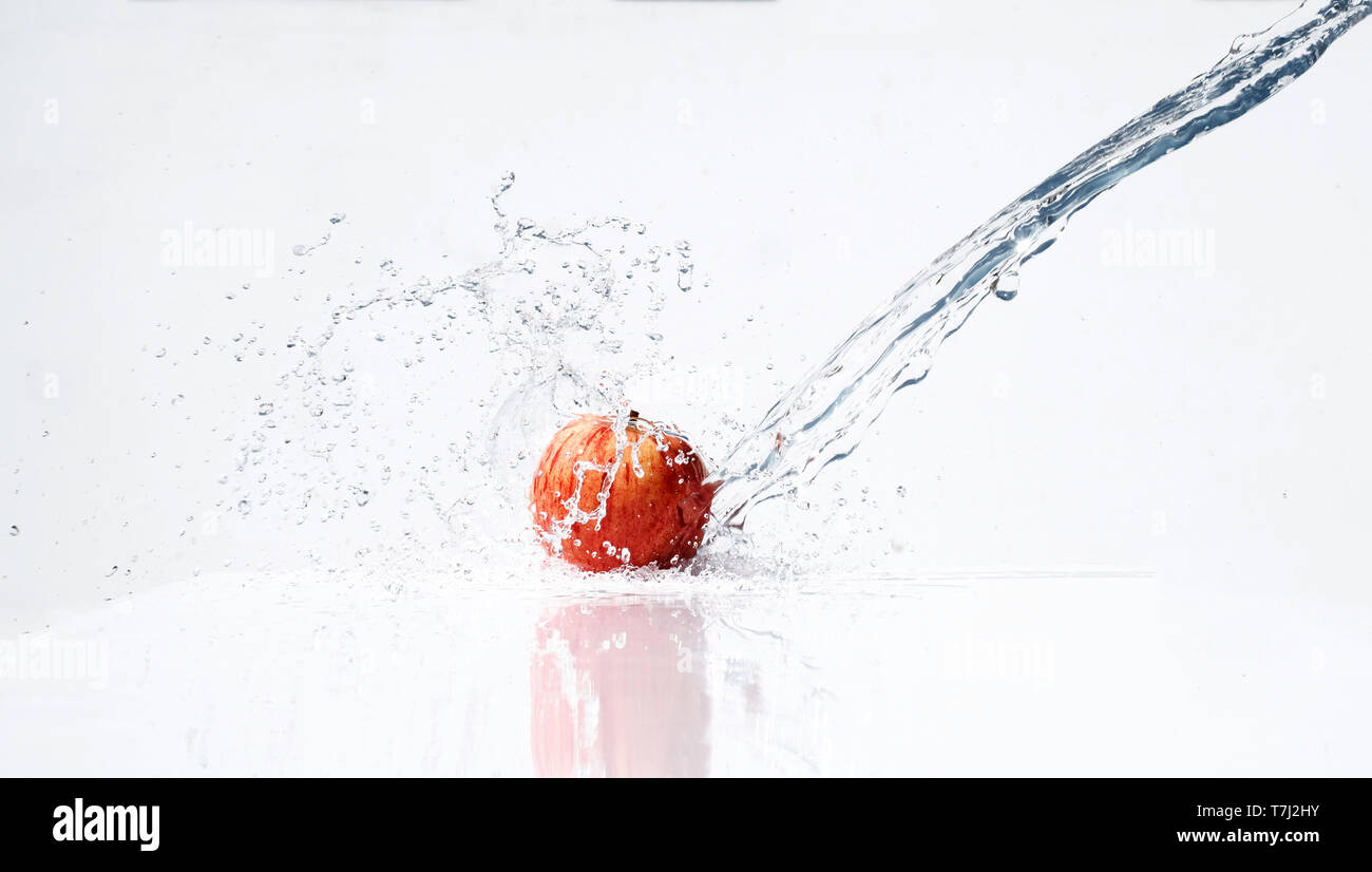 Red apple in water splash on white background Stock Photo - Alamy