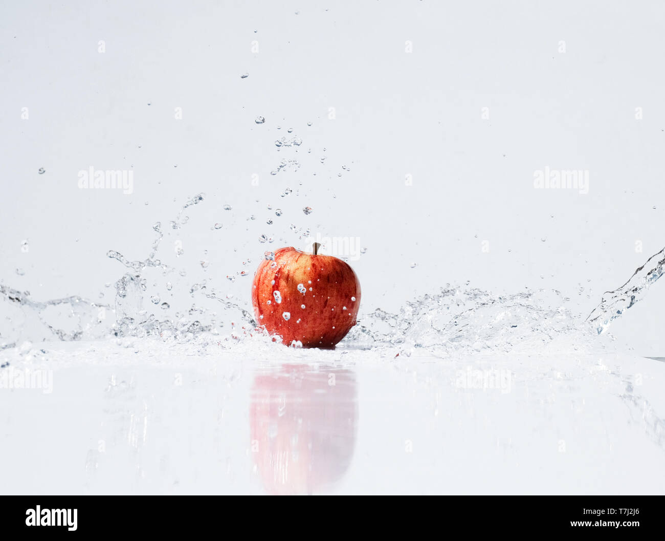 Red apple in water splash on white background Stock Photo - Alamy