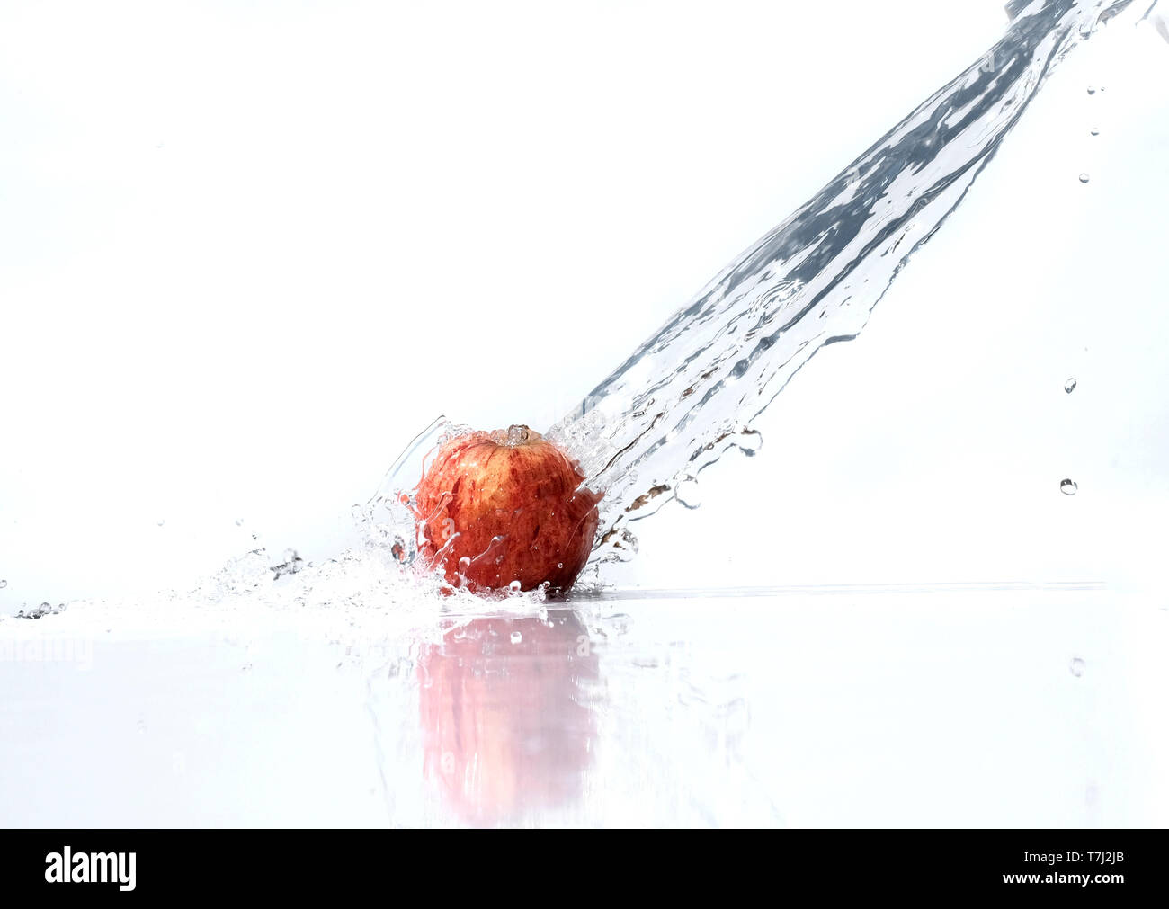 Red apple in water splash on white background Stock Photo - Alamy