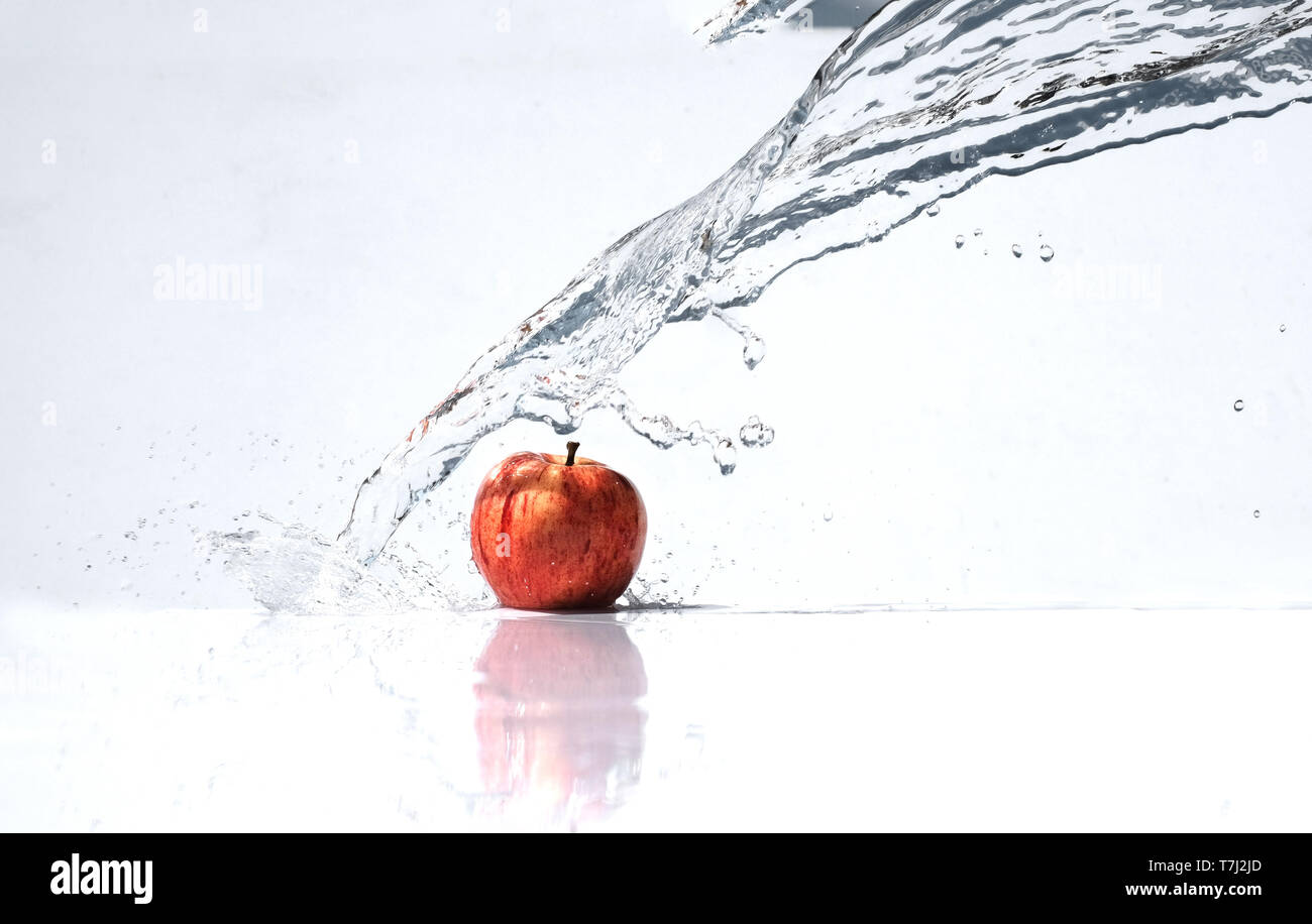 Red apple in water splash on white background Stock Photo - Alamy