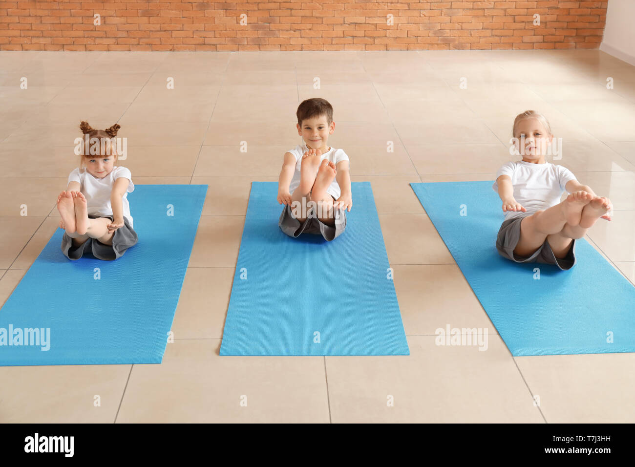 Little children practicing yoga indoors Stock Photo - Alamy