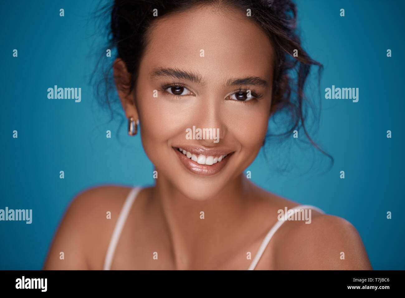 Cute girl at blue background Stock Photo - Alamy