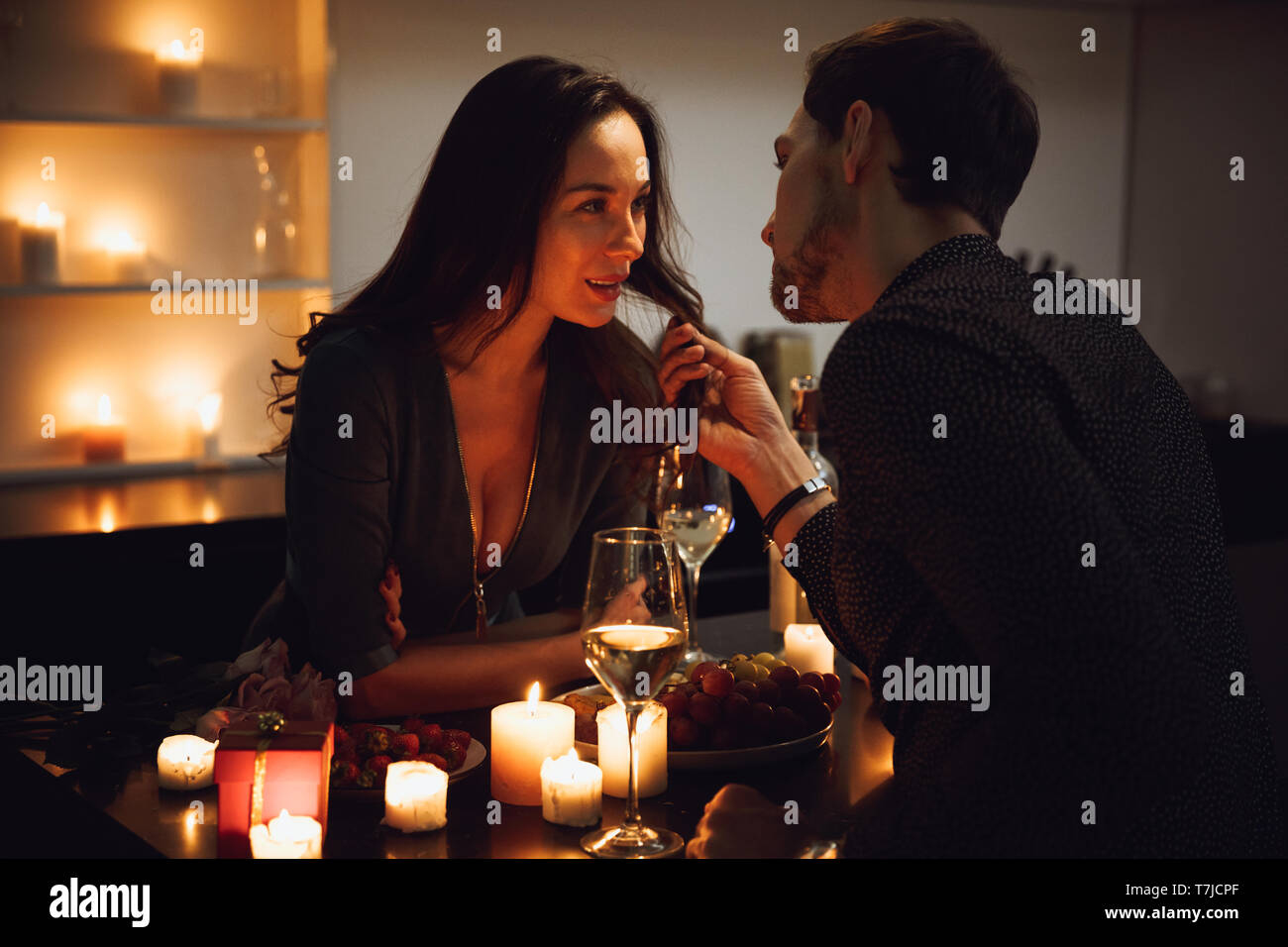 Beautiful passionate couple having a romantic candlelight dinner at ...