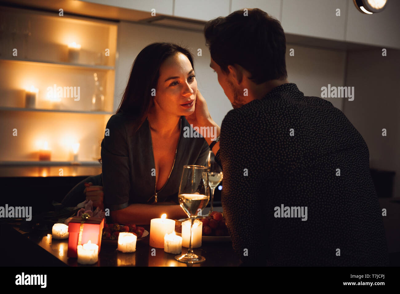 Beautiful passionate couple having a romantic candlelight dinner at ...