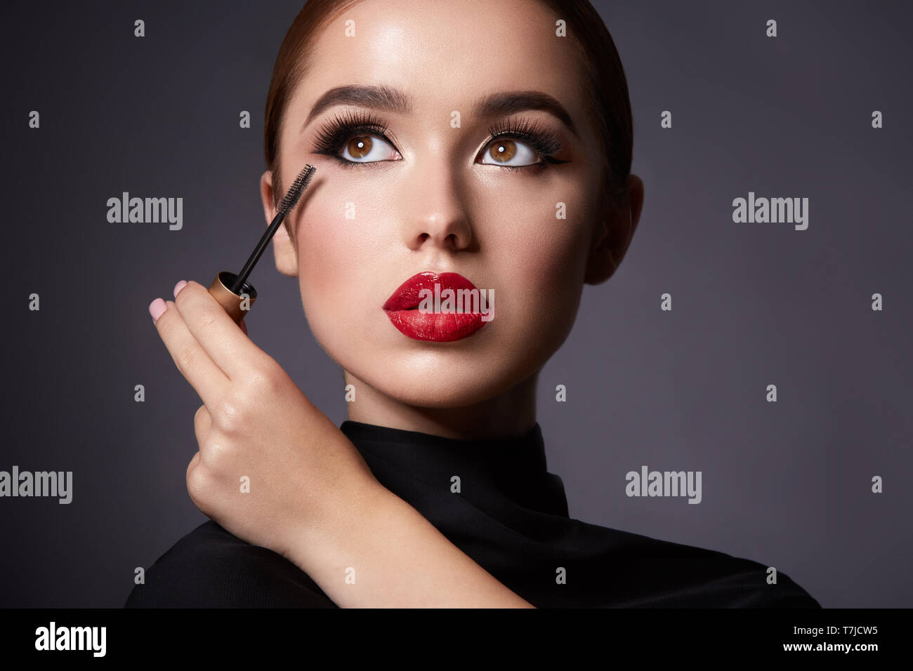 Using mascara at black background Stock Photo - Alamy