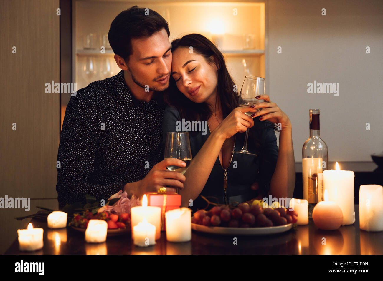 Beautiful passionate couple having a romantic candlelight dinner at ...