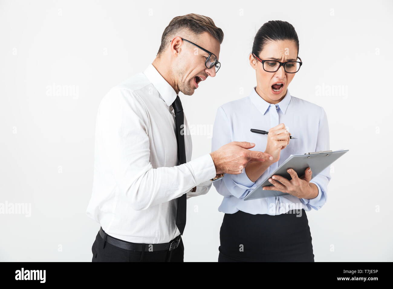 Couple of mad colleagues wearing formal clothing standing isolated over ...