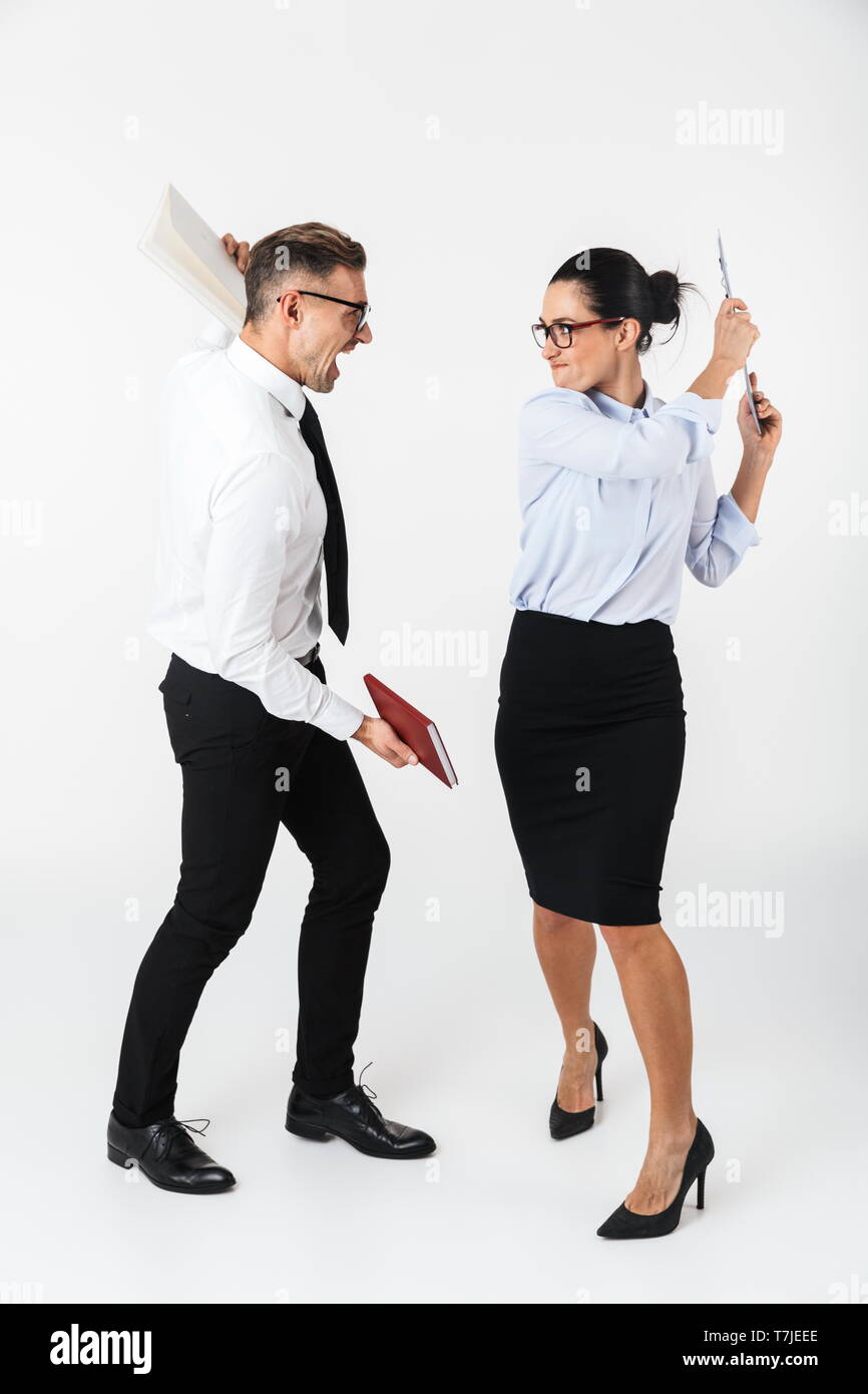Full length of a colleagues couple wearing formal clothing standing ...