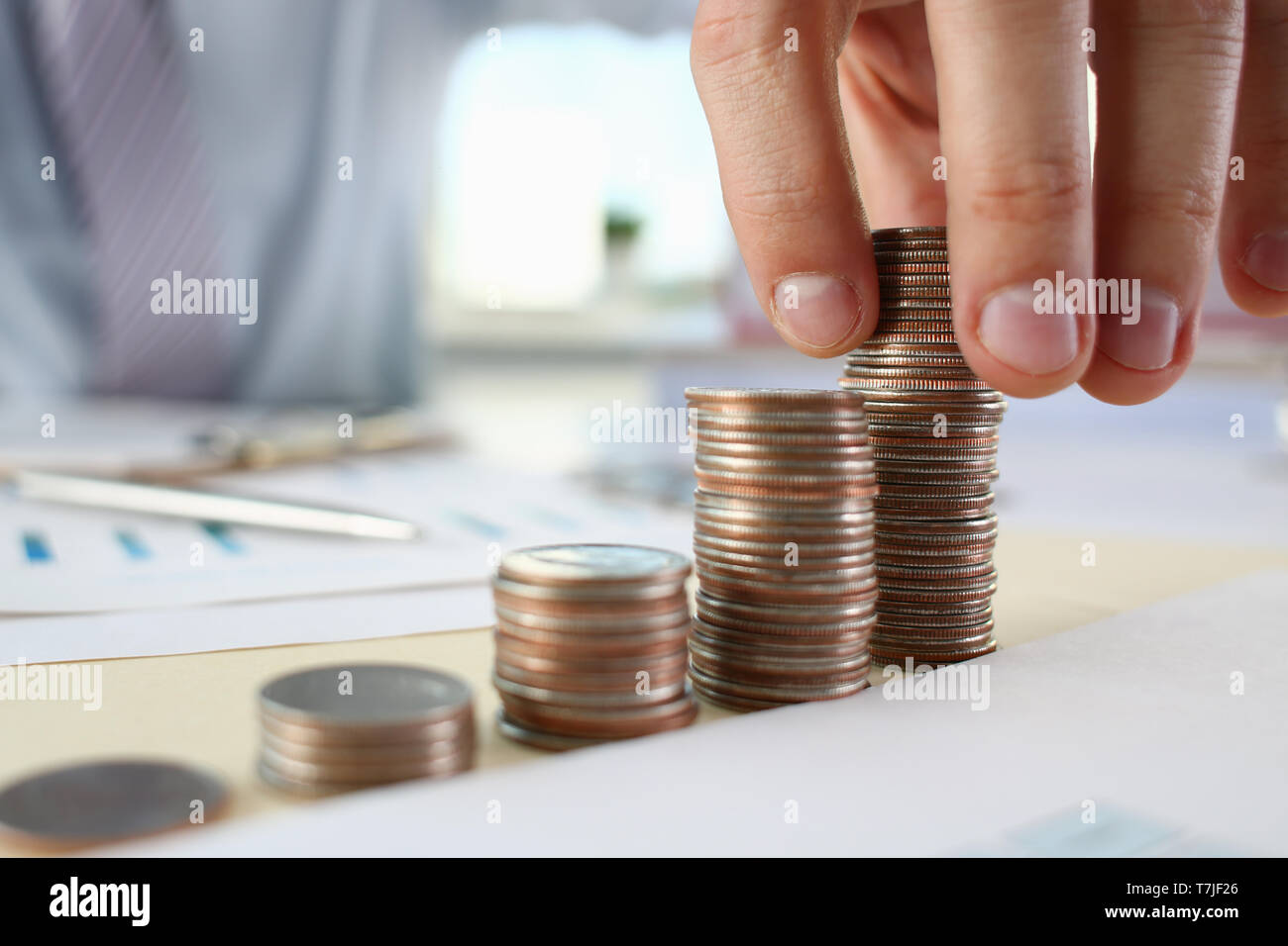 Hand businessman putting pin money Stock Photo - Alamy