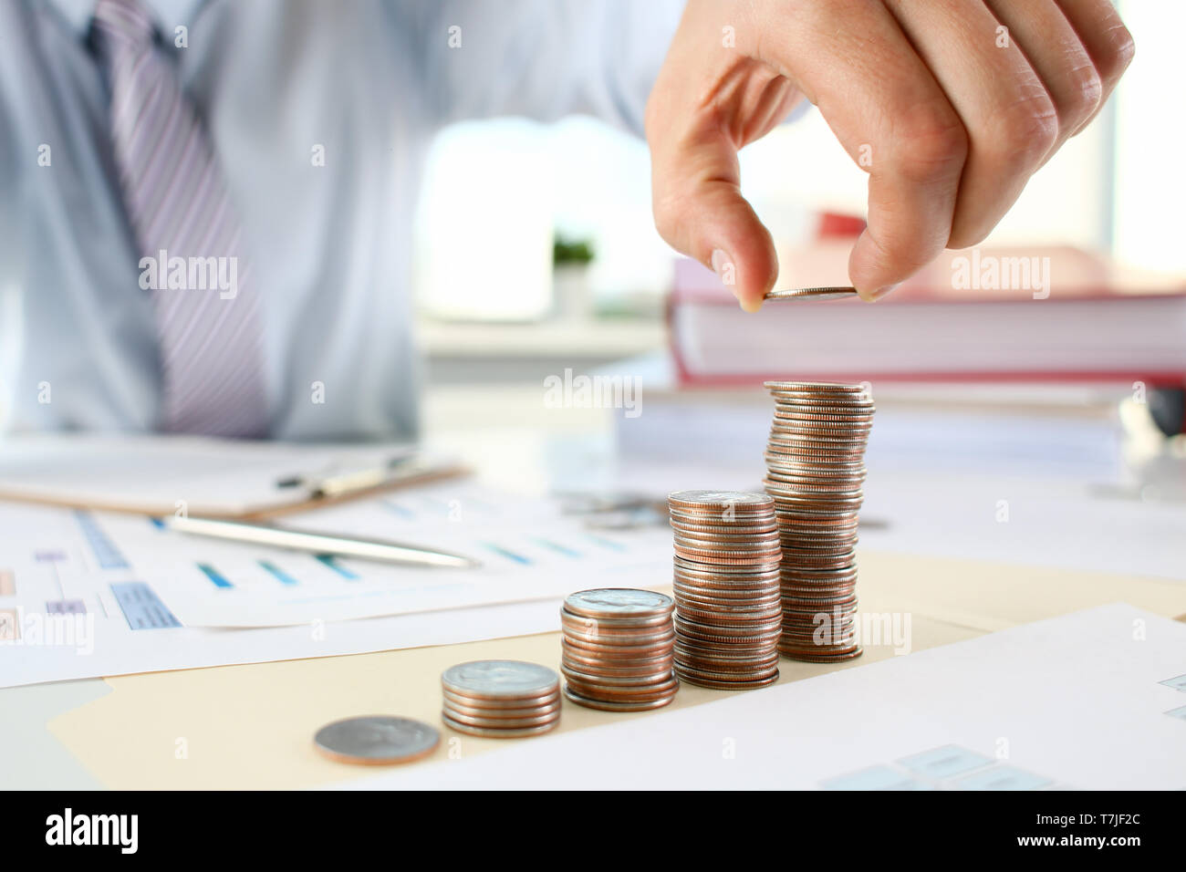 Hand businessman putting pin money Stock Photo - Alamy
