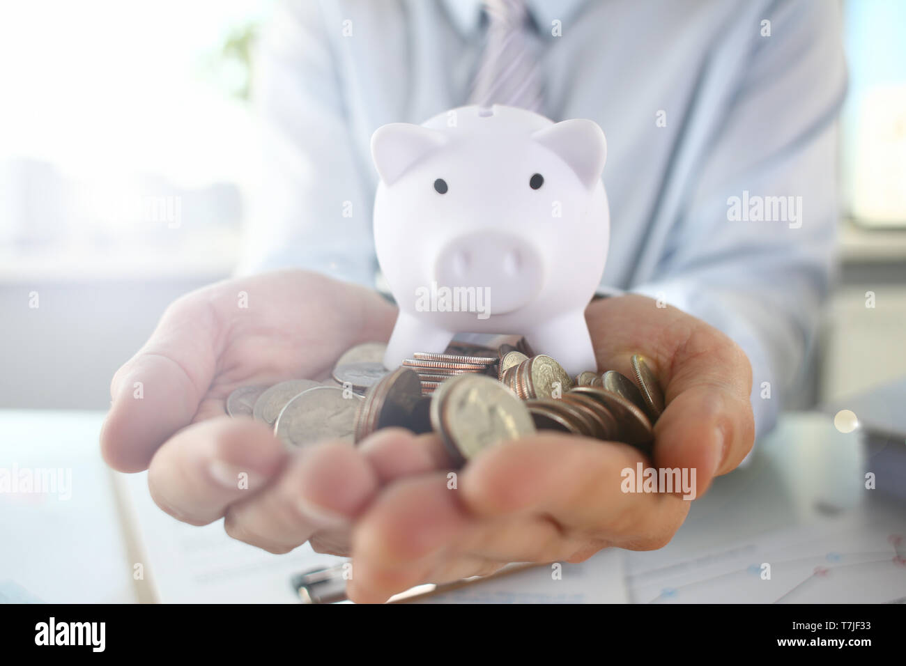 Hand businessman putting pin money Stock Photo - Alamy