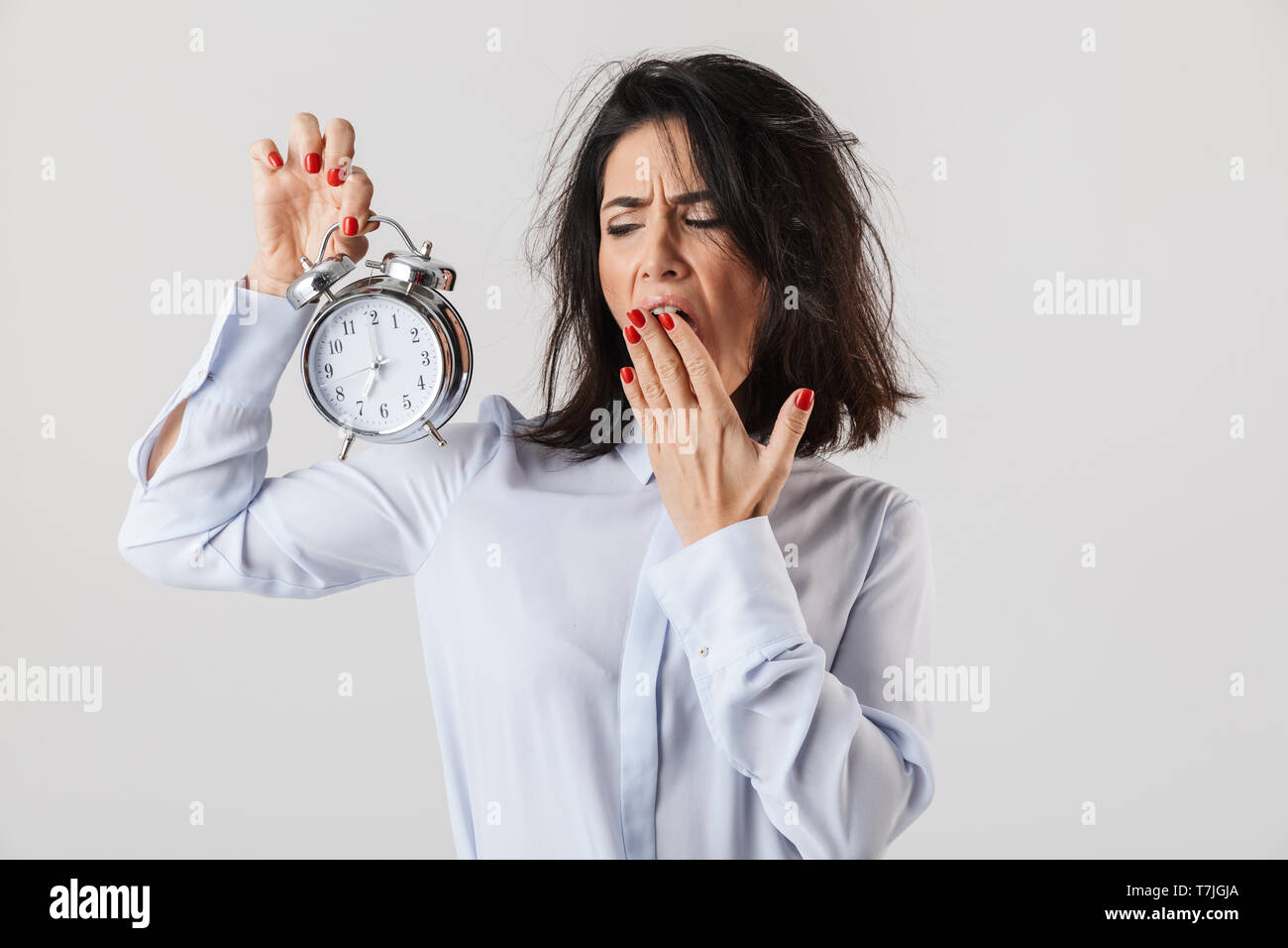 Tired businesswoman smartly dressed standing isolated over white ...