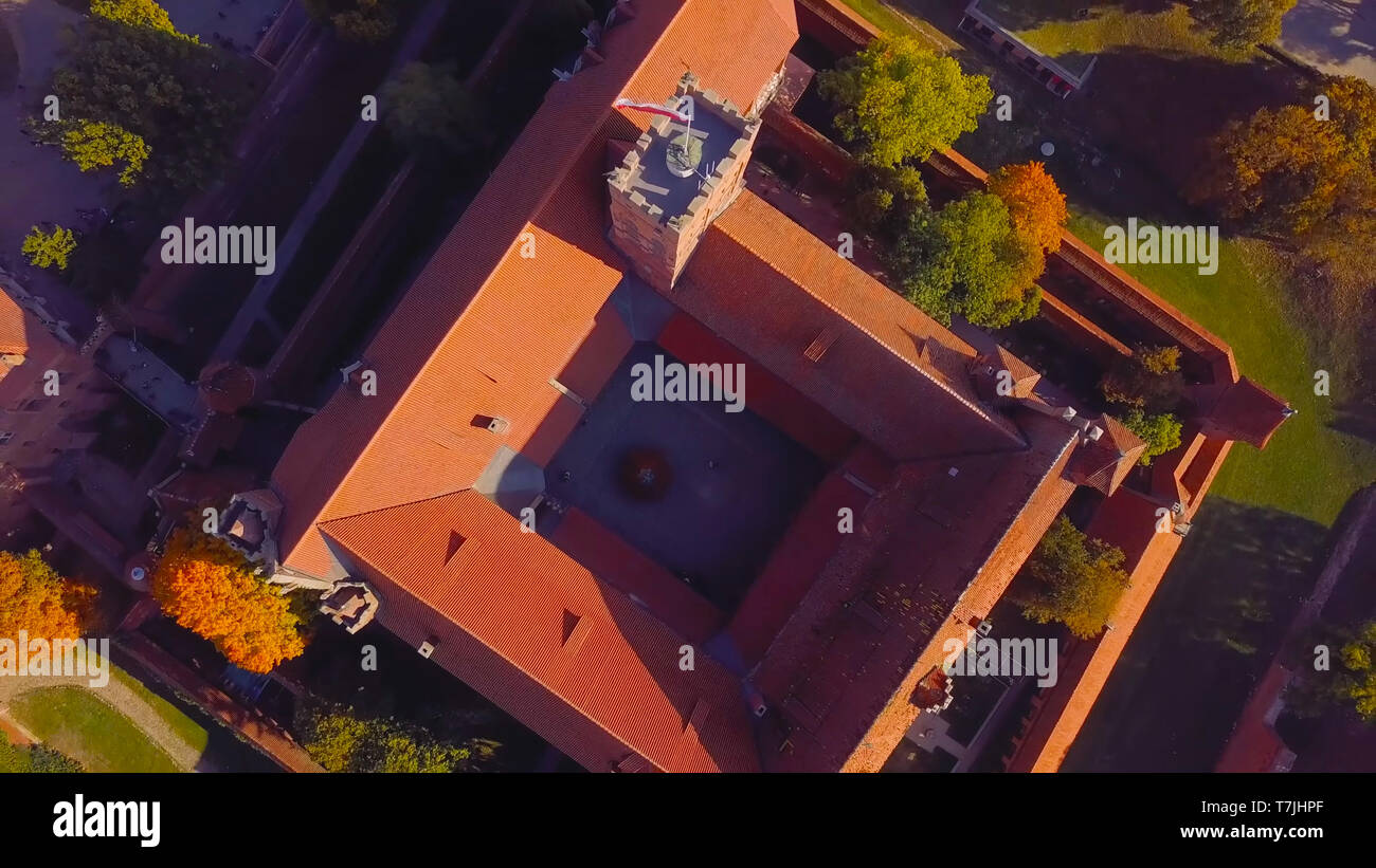 The roof of an old building in Poland. The color of the wall is red in ...